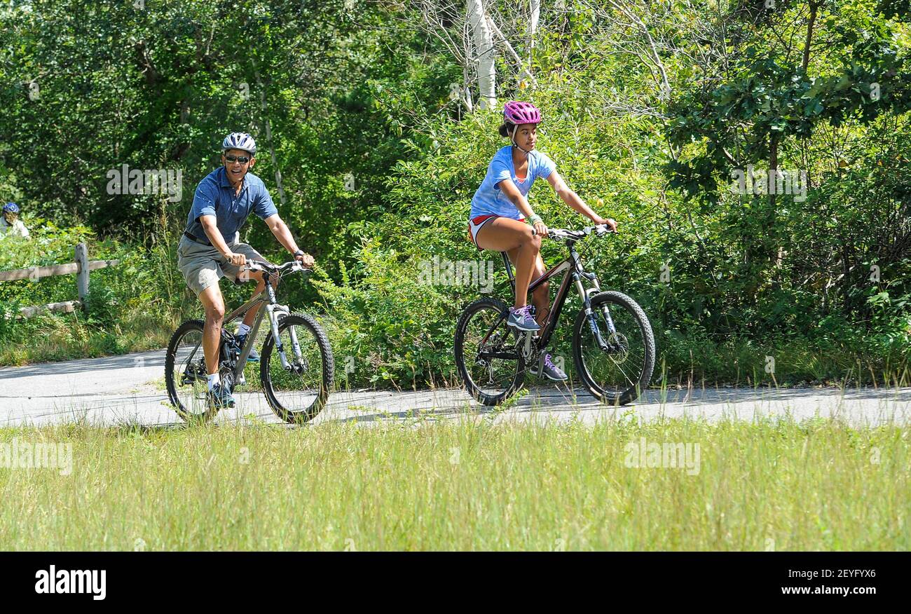 President Barack Obama bike riding with his daughter Malia during their ...