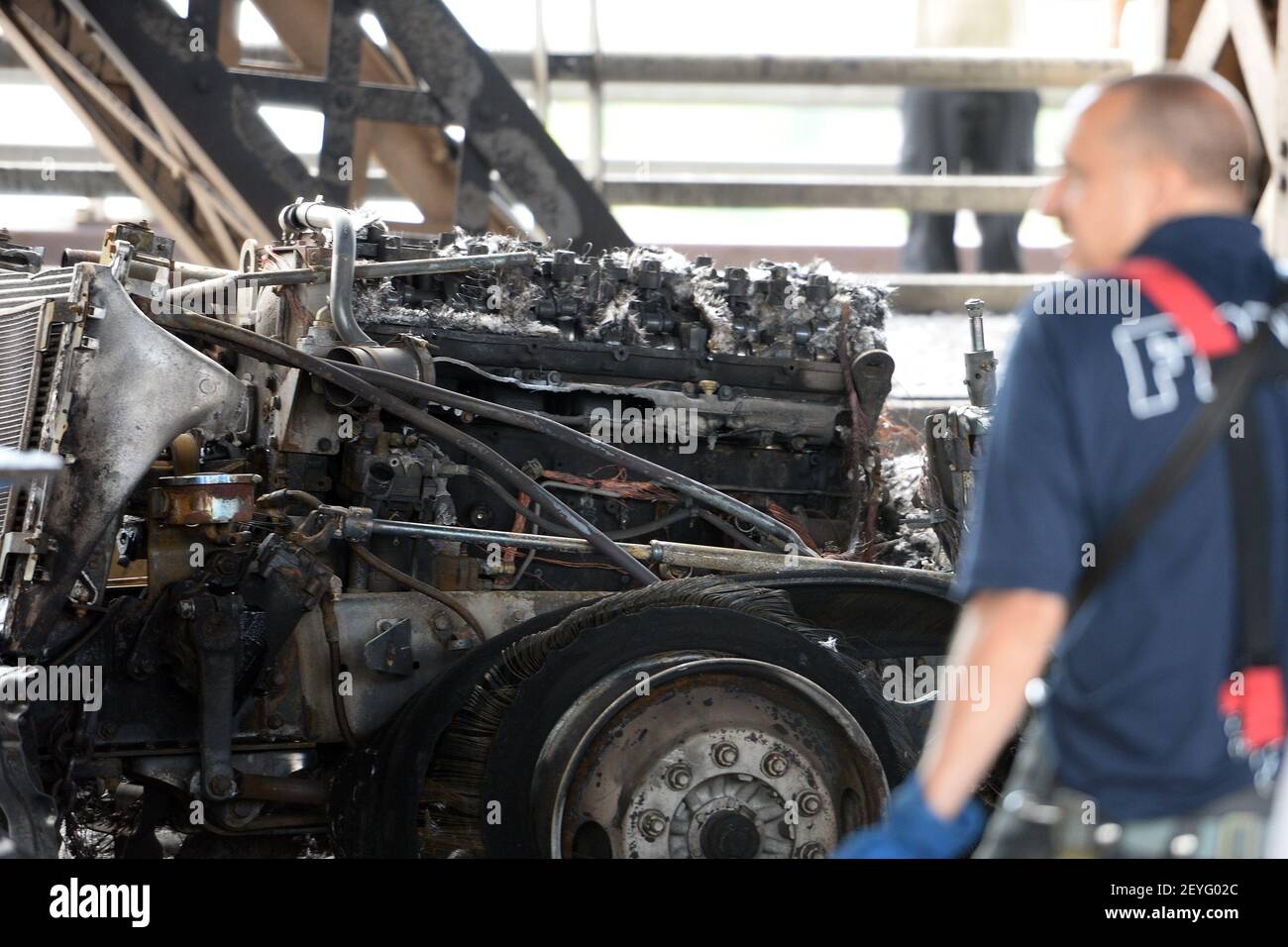 An FDNY fireman stood by the smoldering remains of a big rig engine on ...
