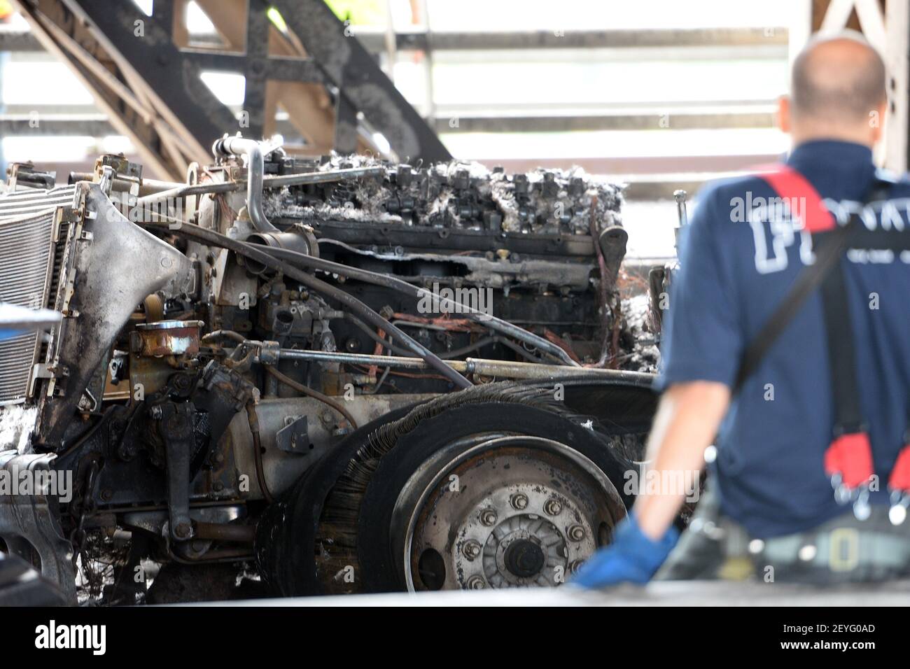 An FDNY fireman stood by the smoldering remains of a big rig engine on ...