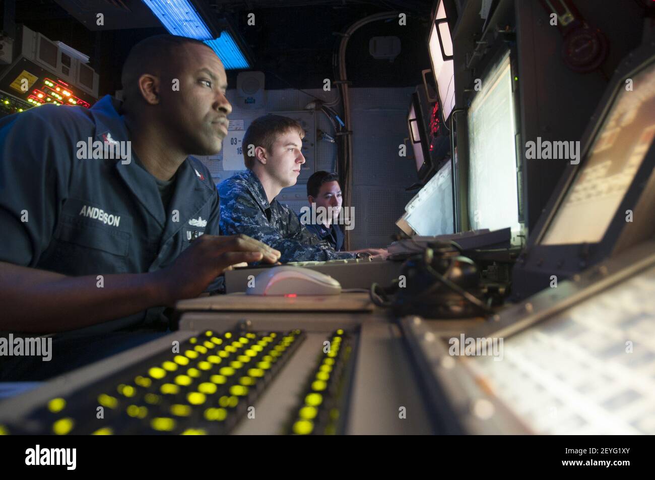 U.S. Navy Operations Specialist 2nd Class Larry Anderson, left, manages ...