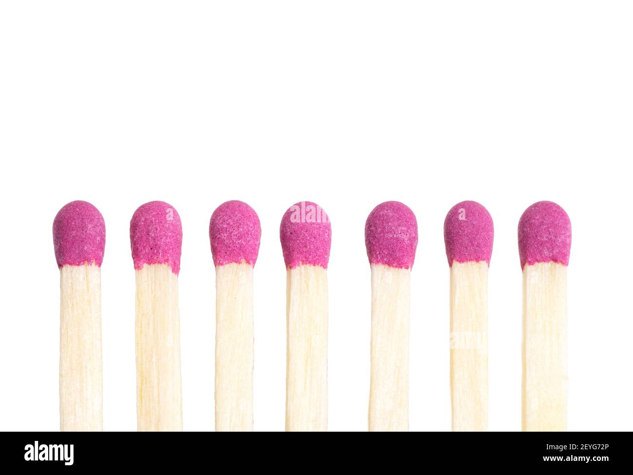Close-up view of matchsticks lined in a row against white background ...