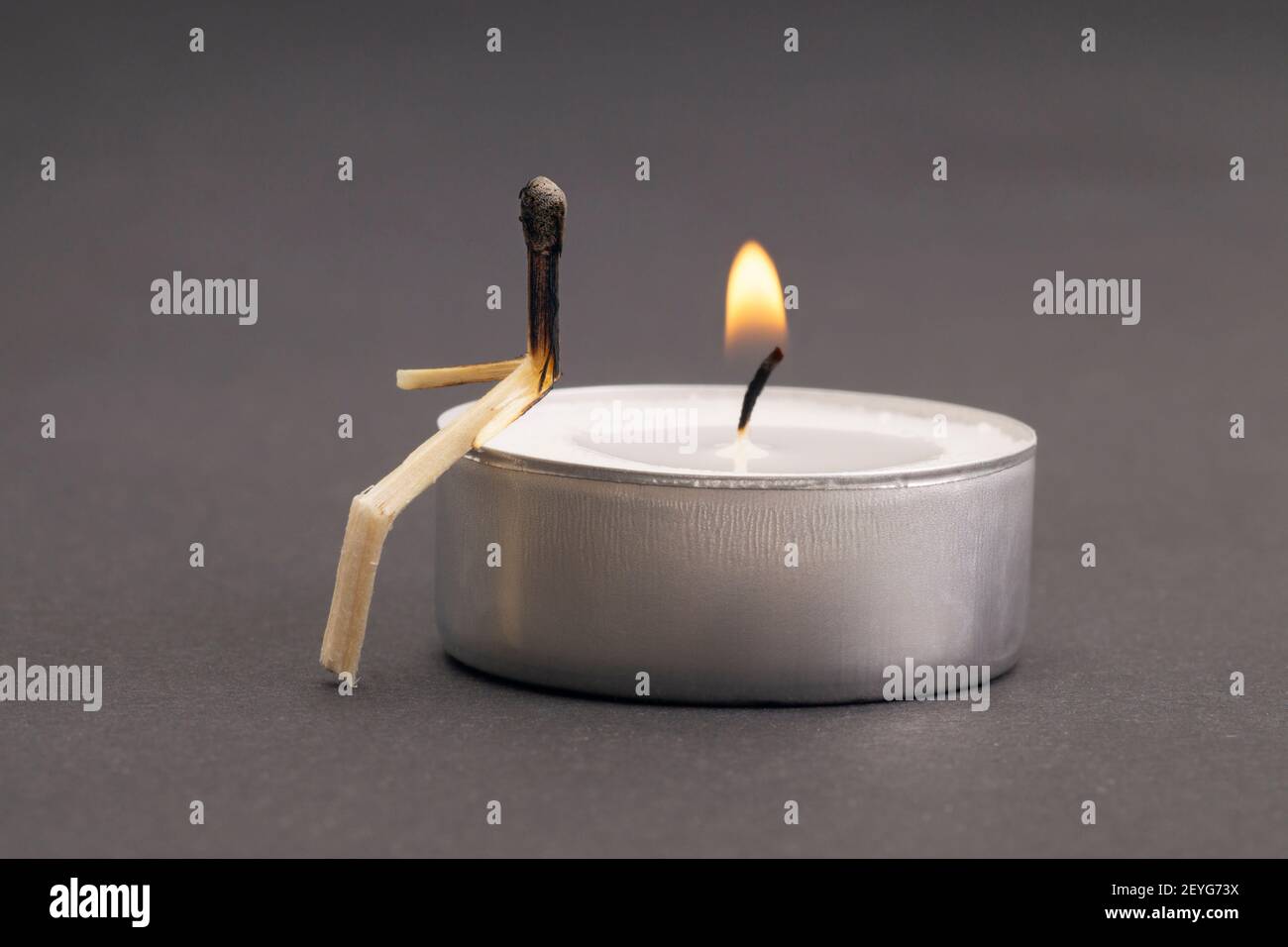 Matchstick character sitting on a lit tea candle. Unrequited love ...