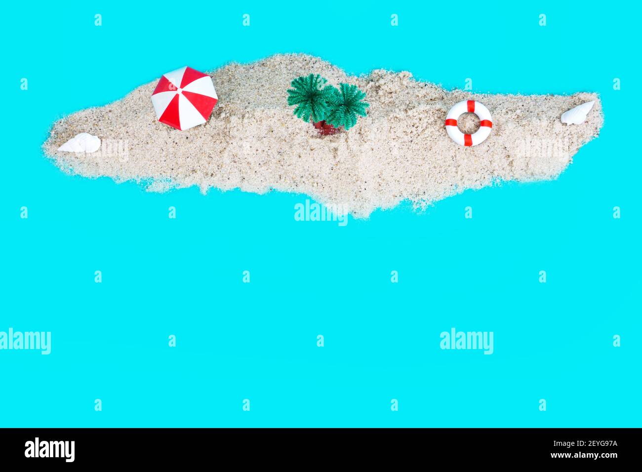 Creative flat lay of sand, toy sun umbrella, lifebuoy and seashells on ...