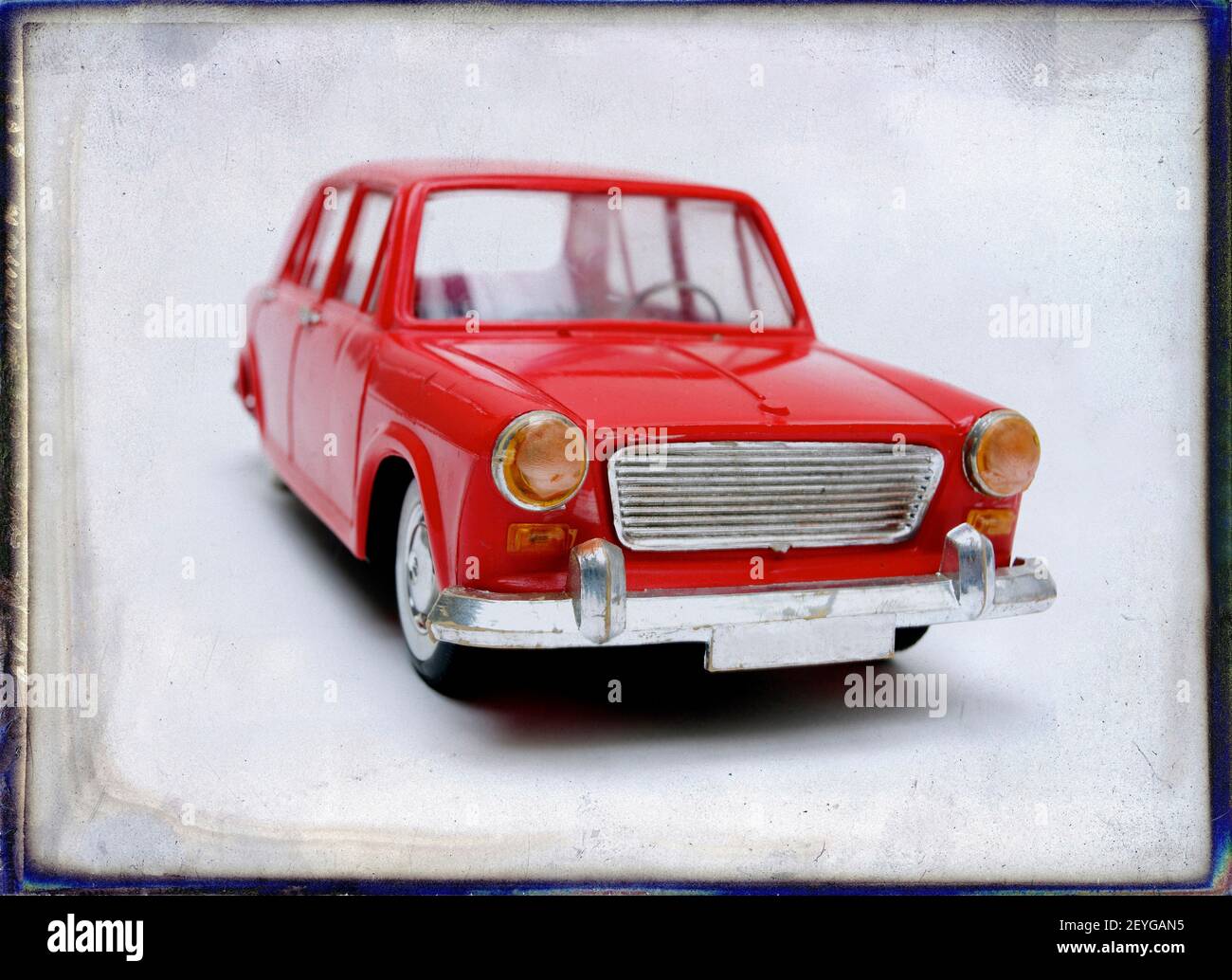 A close-up view of a classic red toy car showcasing intricate details ...