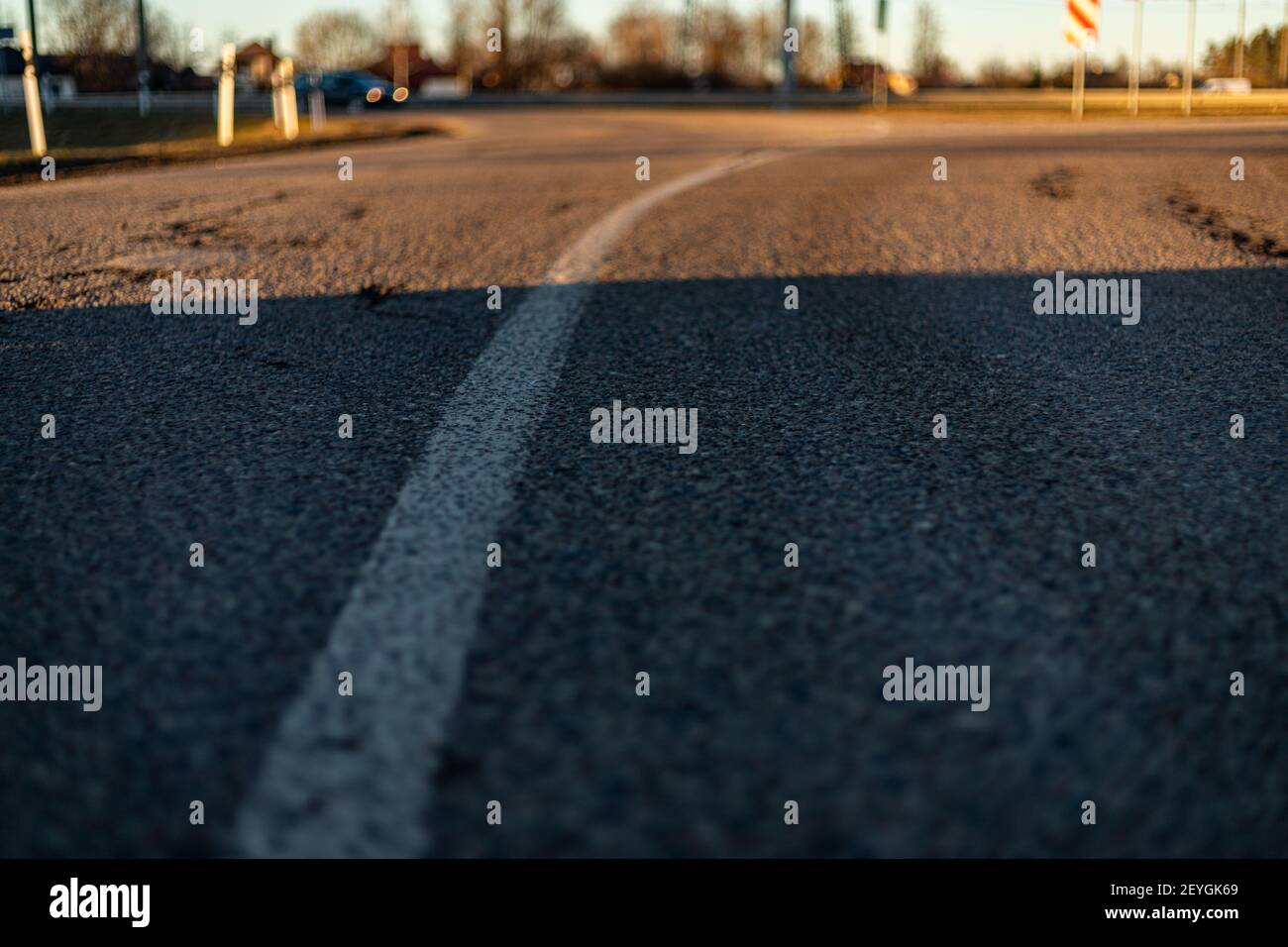 Black asphalt road and white dividing line Stock Photo - Alamy