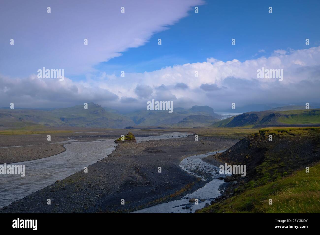 A beautiful landscape with greenery, hills and body of water under a ...