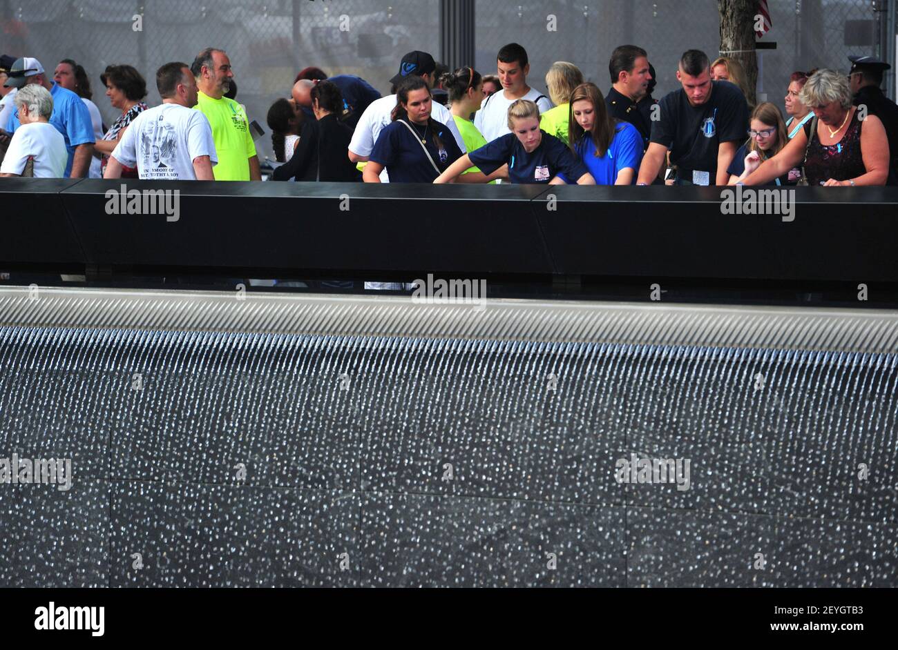 People gather at the South reflecting pool at the 9/11 Memorial during ...