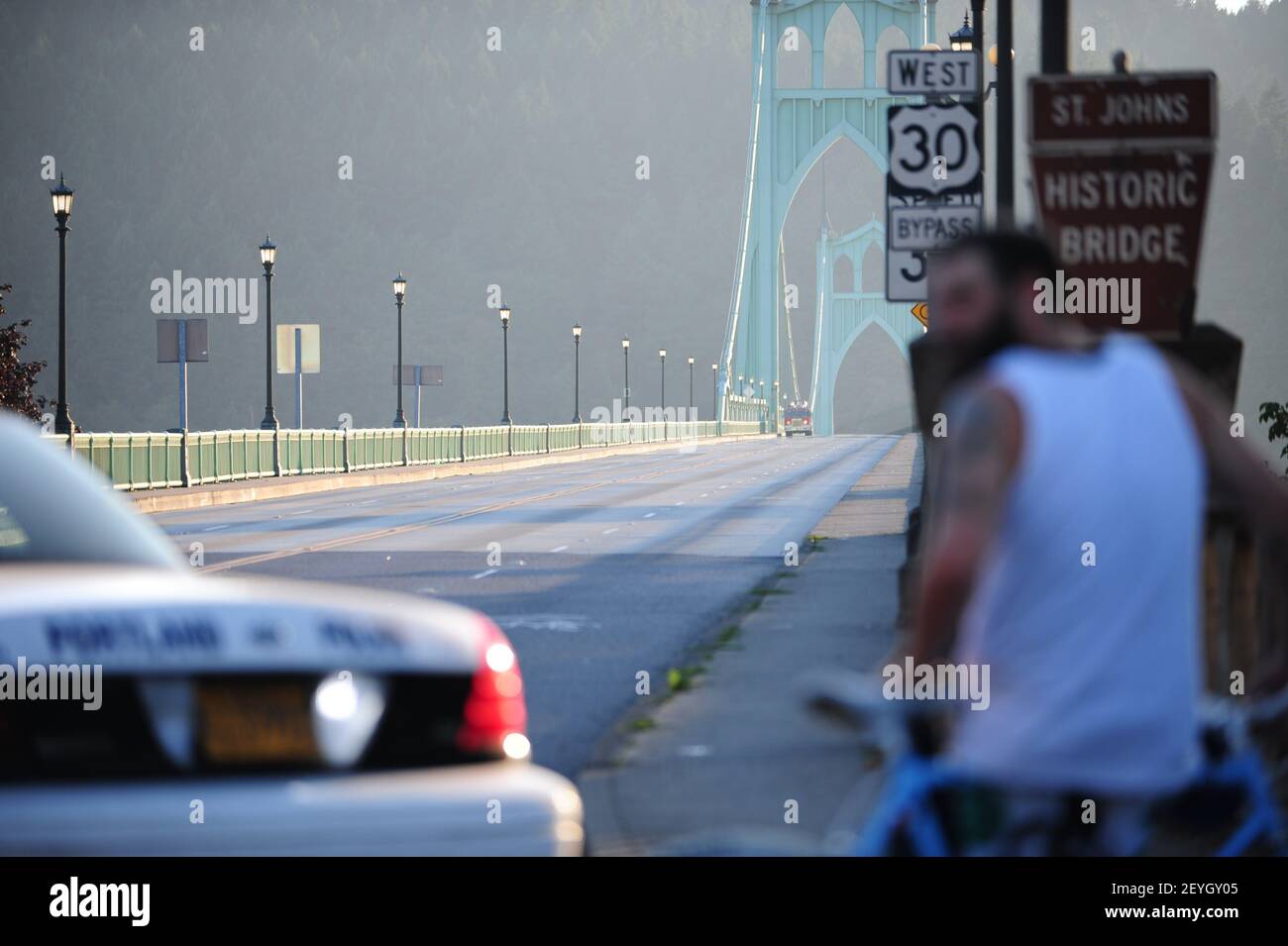 A local resident examines the scene as police block traffic from ...