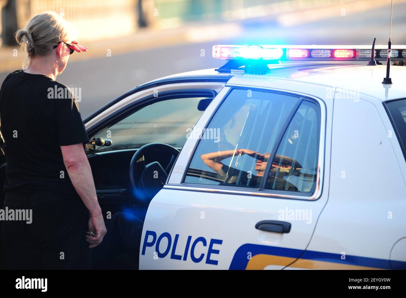 A local resident examines the scene as police block traffic from ...