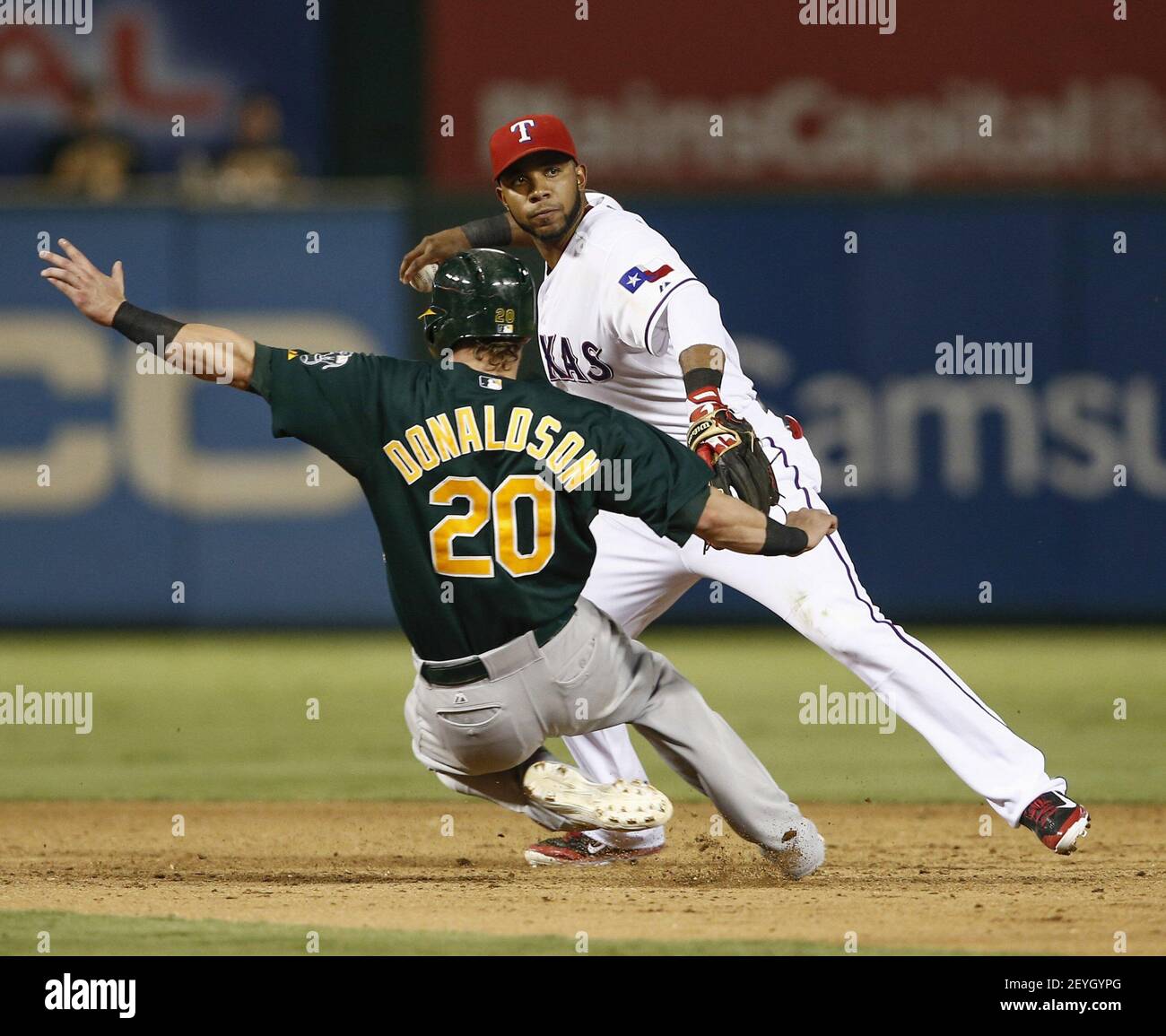 Texas Rangers shortstop Elvis Andrus turns the front end of a double ...