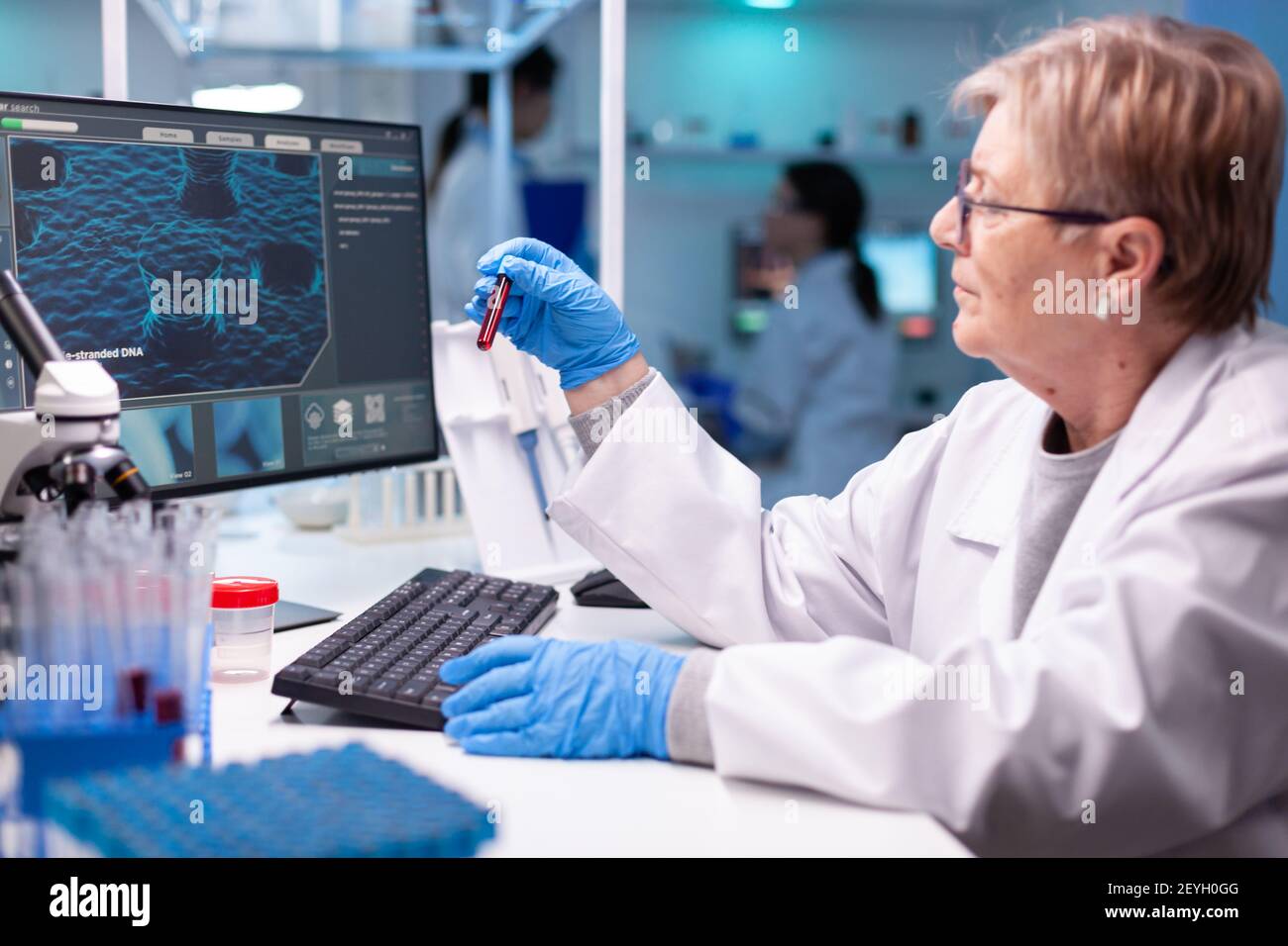 Scientist chemist taking a DNA sample for medical discovery. Researcher ...