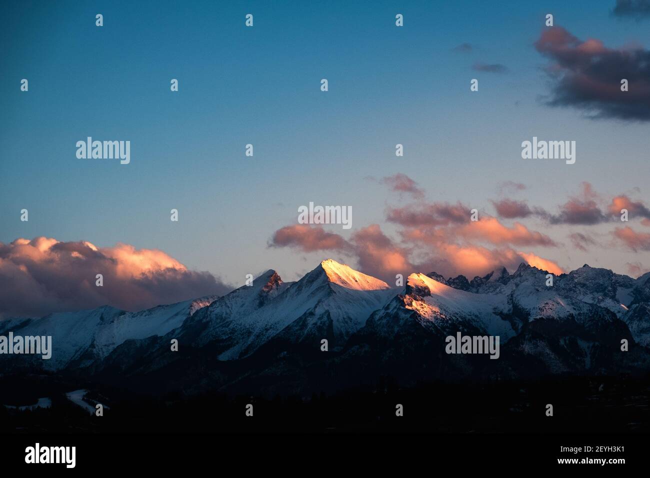 The beautiful snow-capped mountains at scenic sunset Stock Photo - Alamy