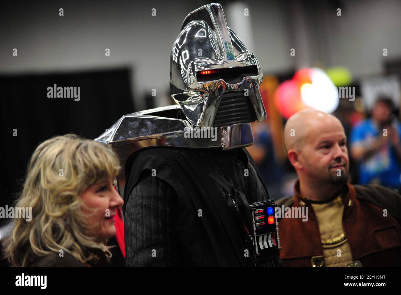 A man dressed as a Cylon from Battlestar Galactica poses for photos, in ...