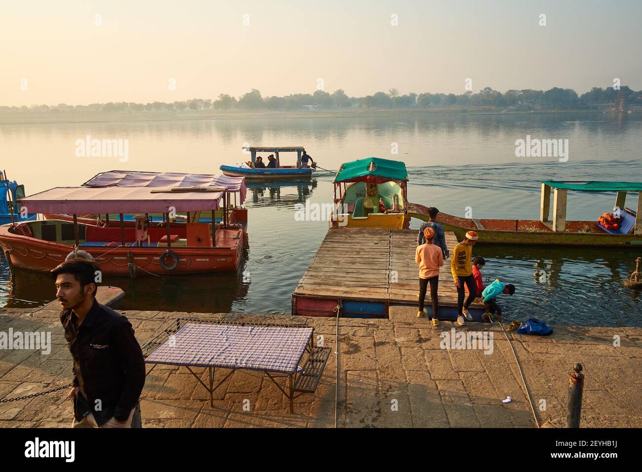 Tourists hang around the boating jetty at Maheshwar in Madhya Pradesh ...