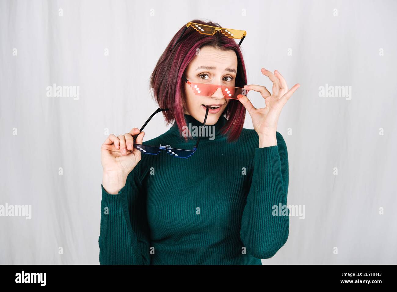 Funny Woman Trying Many Color Pixel Eyeglasses. Young Happy girl with ...