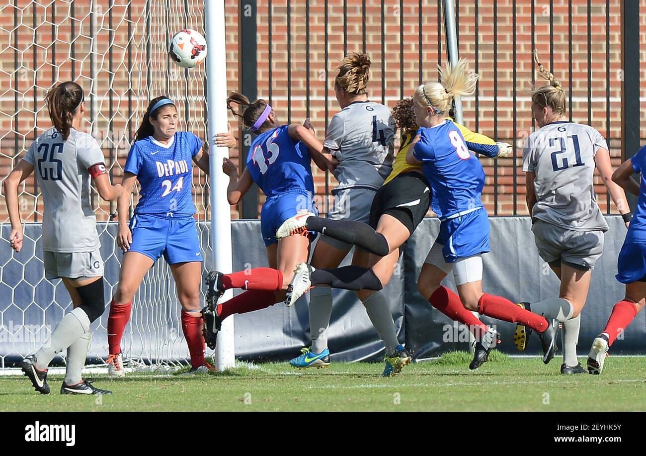 Georgetown defender Mary Kroening (21) scores through a crowd on a ...