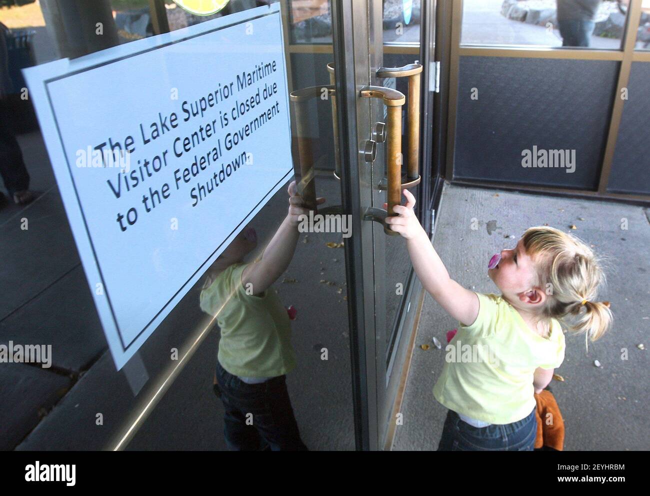 Madison Meyenburg, 2, of Elk River, Minnesota, attempts to open the ...