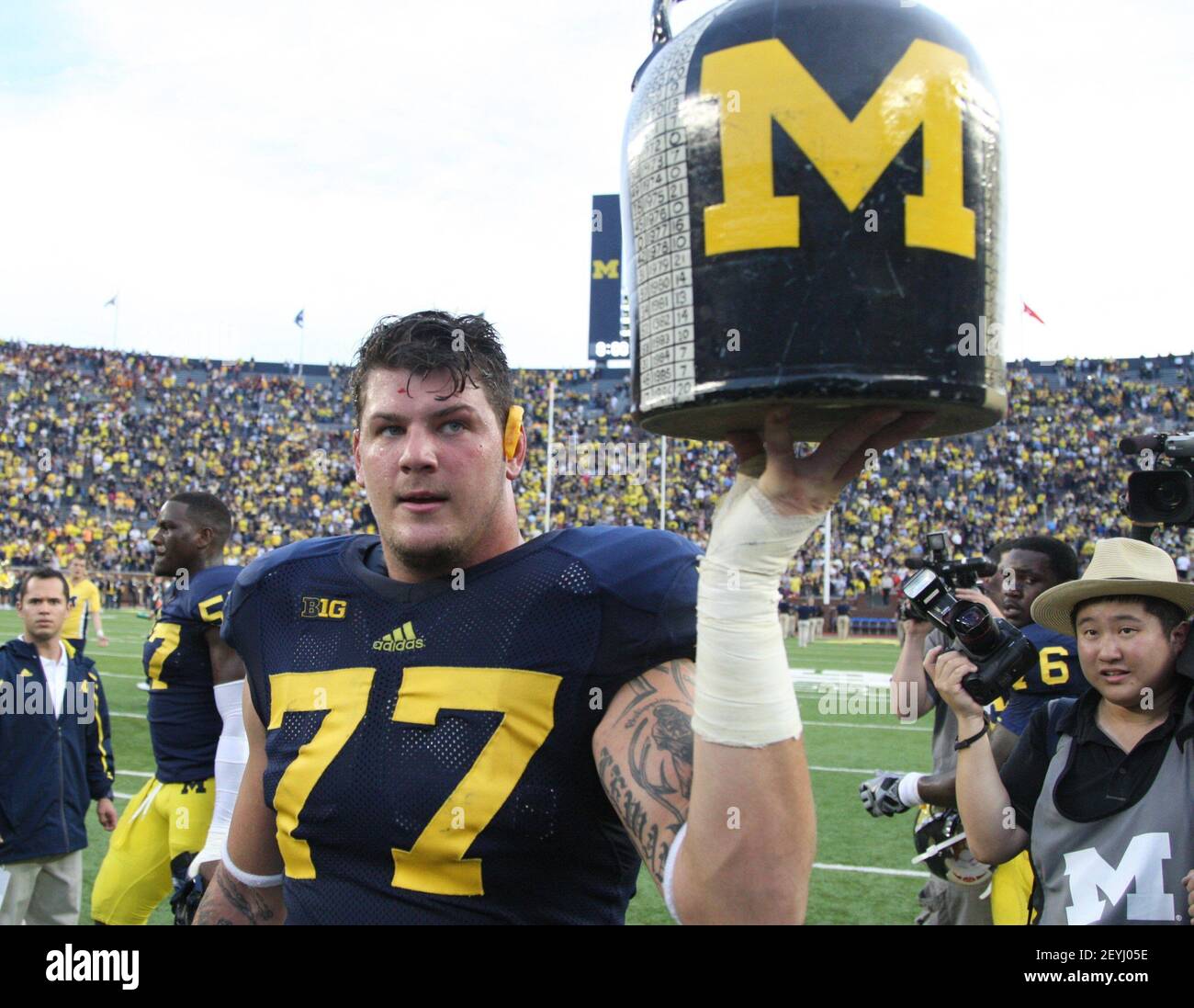 Michigan's Taylor Lewan holds the Brown Jug after beating Minnesota 42 ...