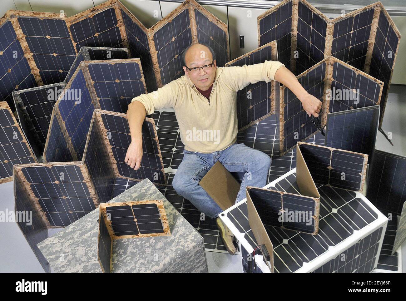 Dr. Osbert Cheung sits among folding solar panels at SBM solar in ...