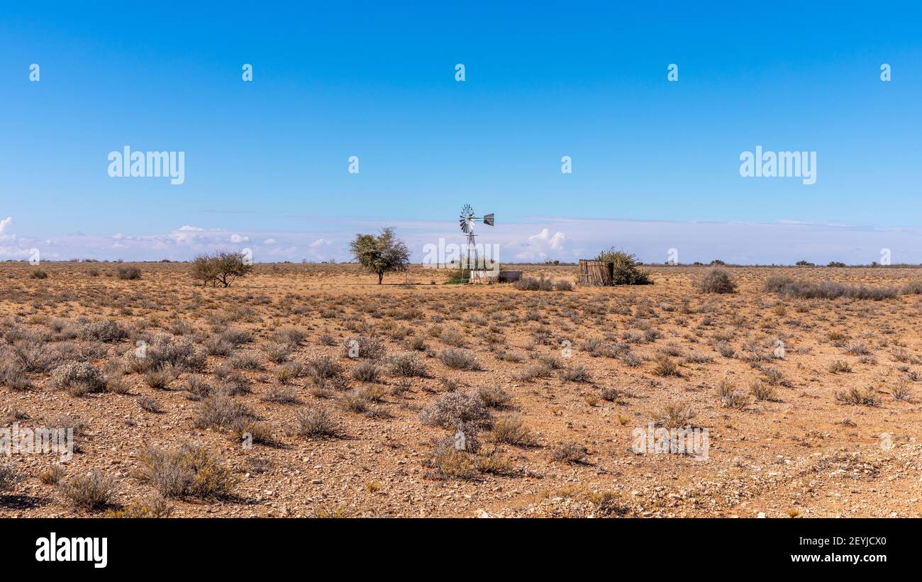Windmill in a breathtaking landscape in the Kalahari desert of Namibia ...