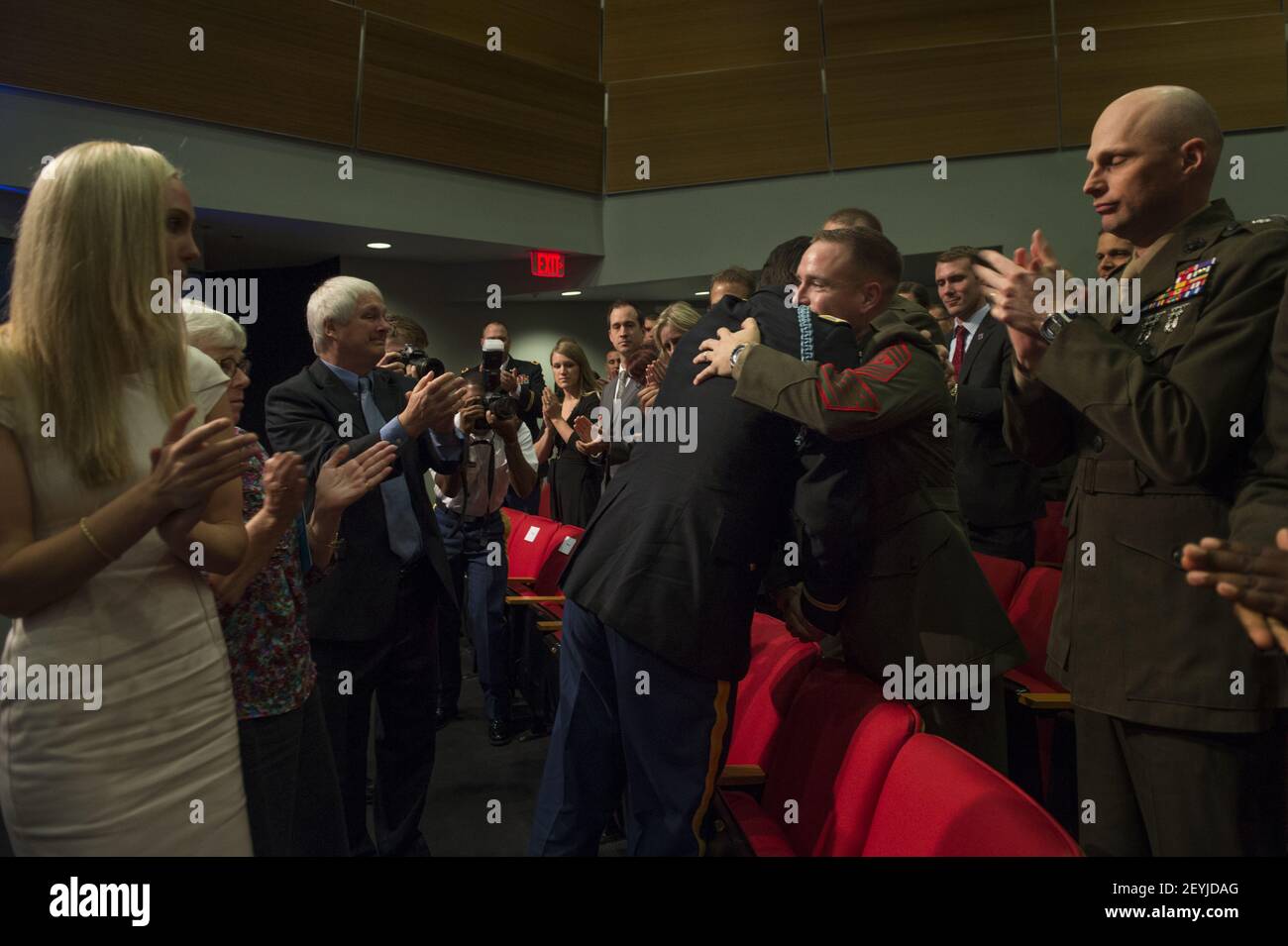 Former Army Capt. William Swenson embraces a Marine he served with in ...
