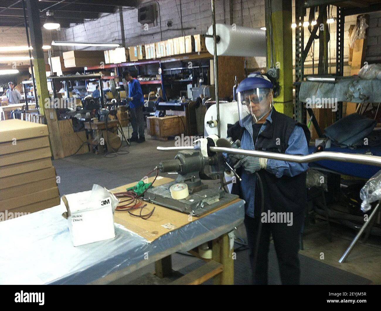 Miriam Casanova, of Olney, polishes a handrail, September 24, 2013, at ...