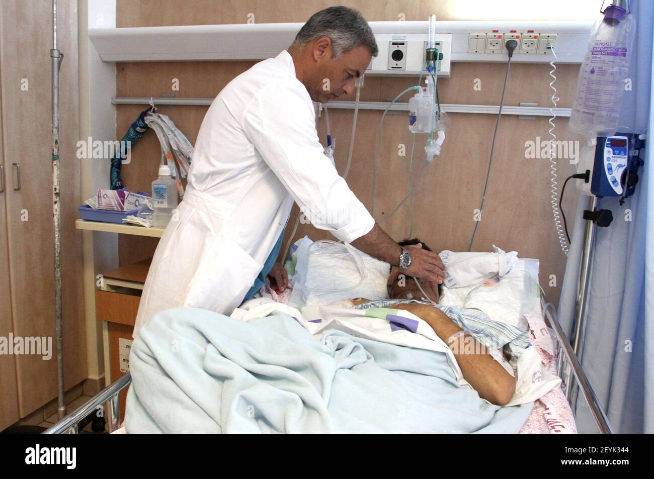 Dr. Eyal Sela checks on a Syrian patient after a long and difficult ...