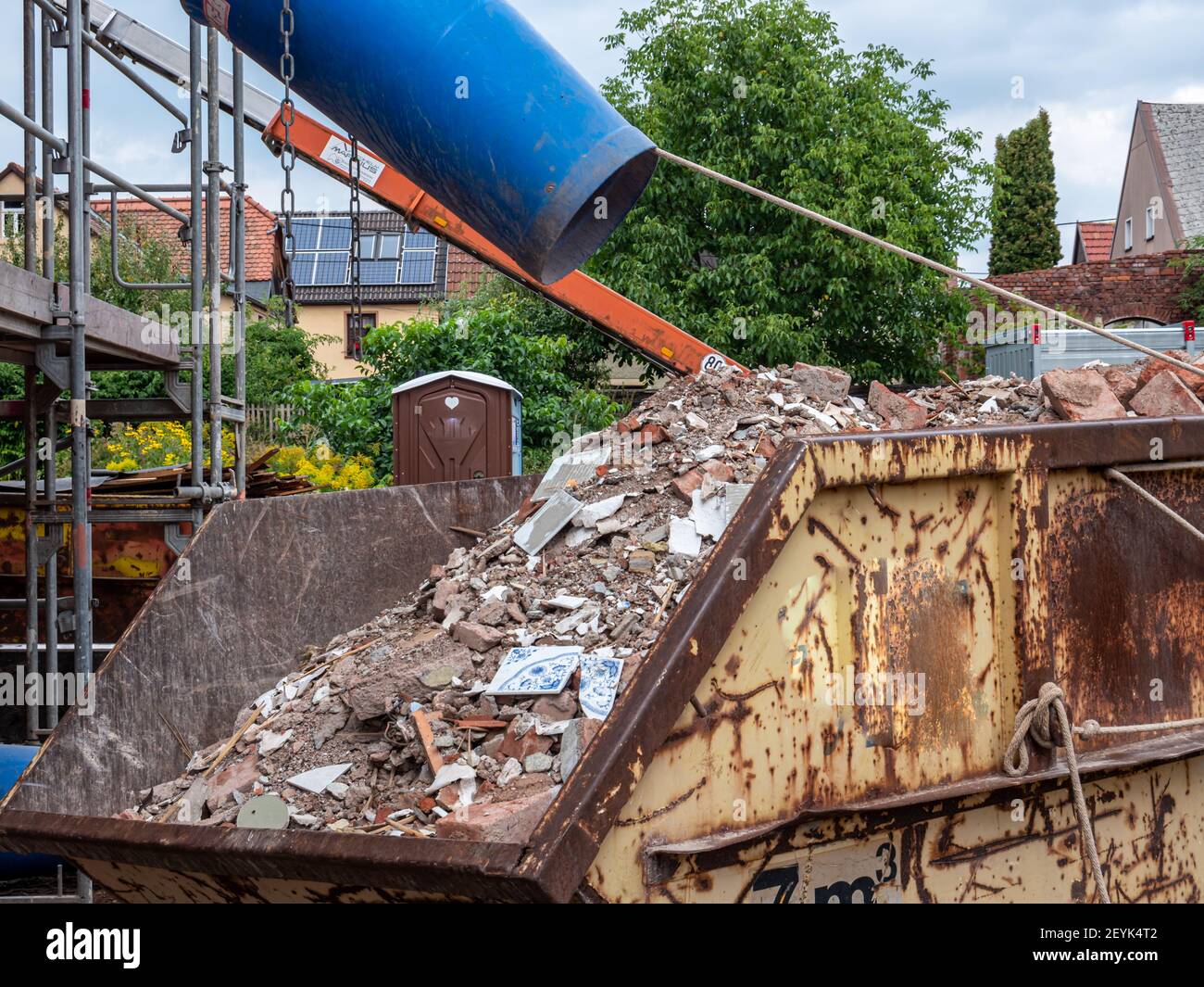 Container with rubble and rubble chute Stock Photo - Alamy