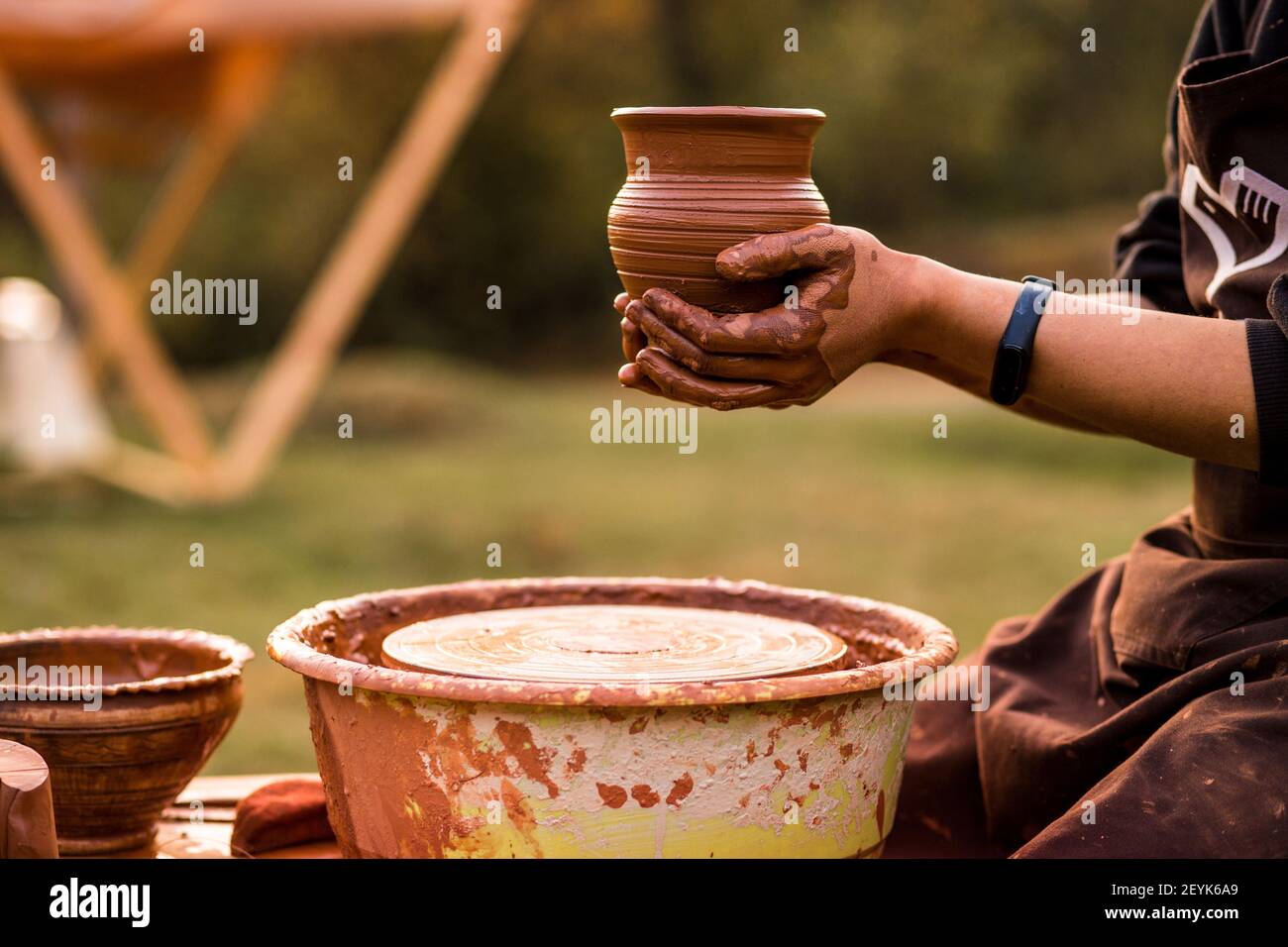 Pottery man hands hold clay pot on his workshop Stock Photo - Alamy