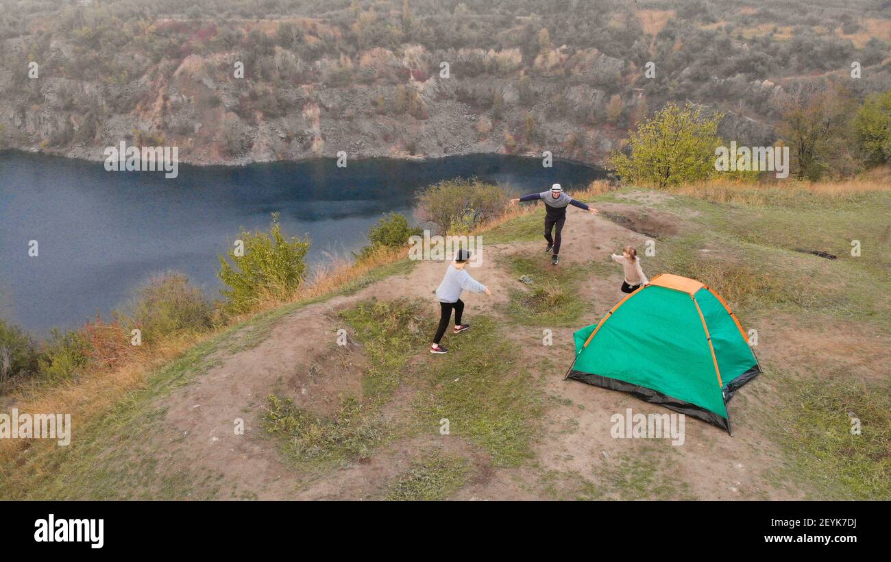 Aerial top view of family in campsite from above, parents and kid relax ...