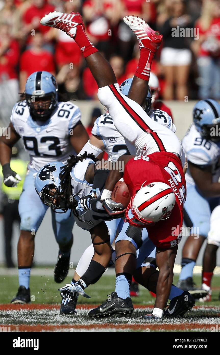 North Carolina safety Tre Boston (10) upends N.C. State tight end Asa ...