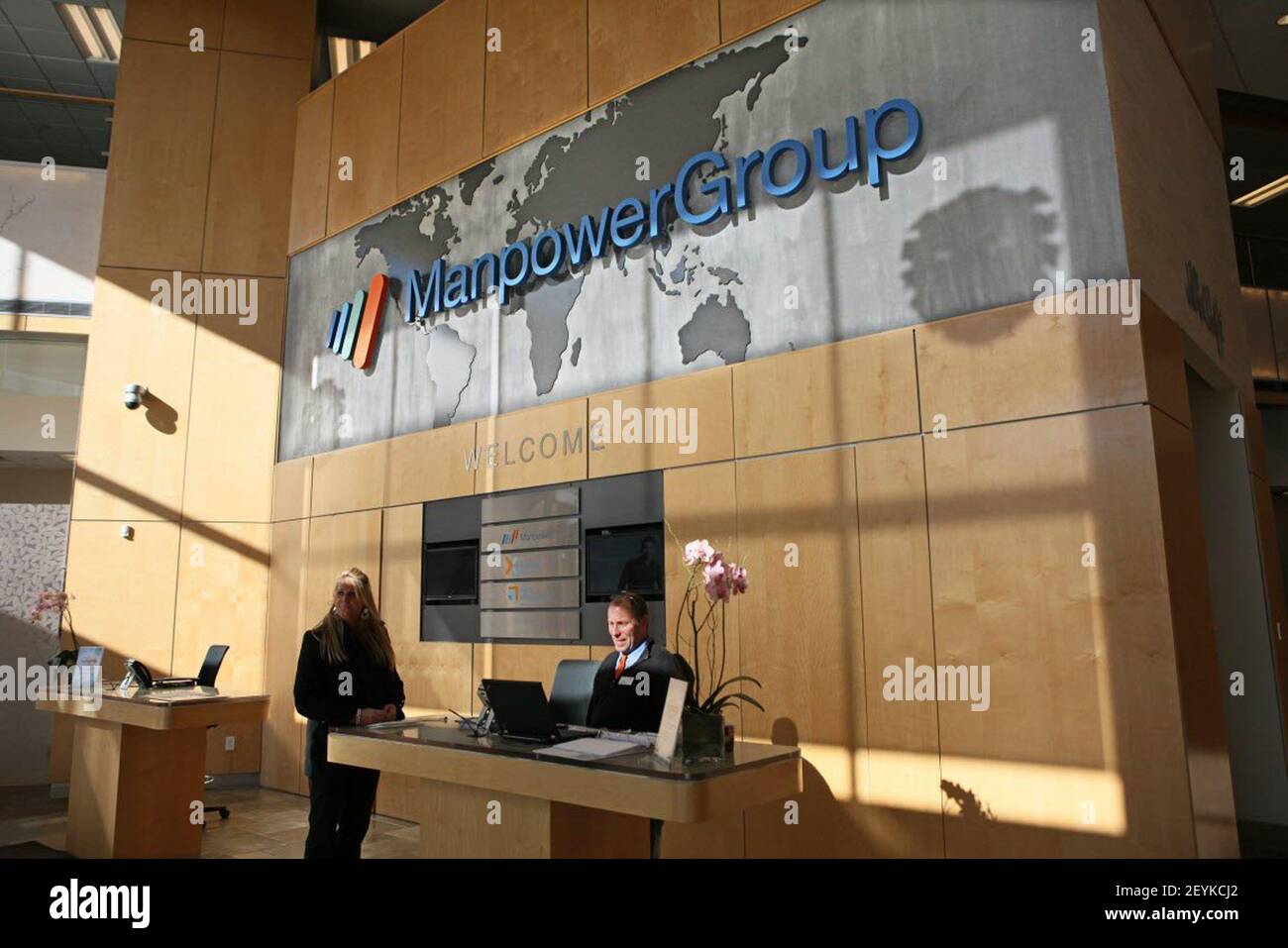 A world map is seen behind the company name, Manpower's downtown ...