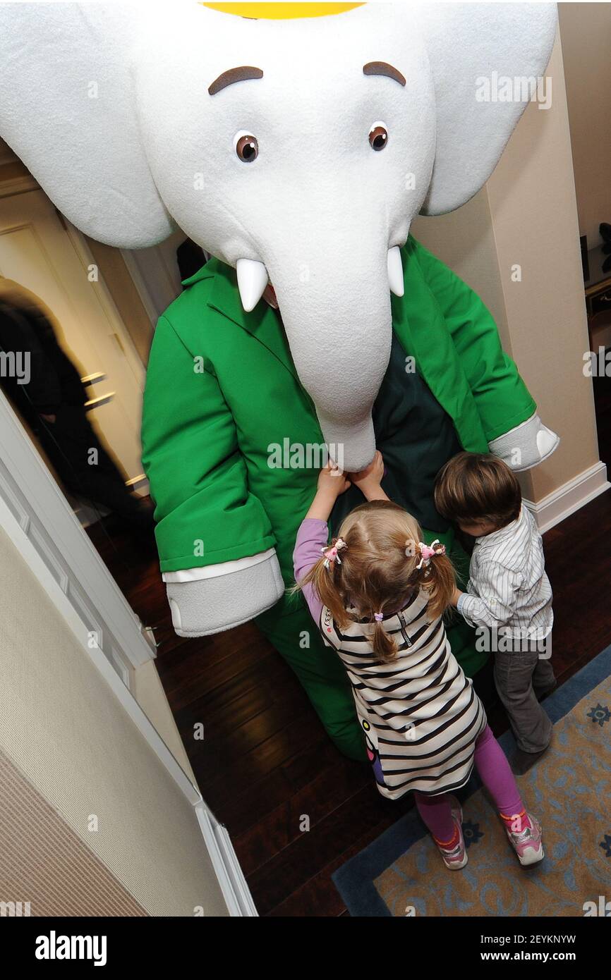 A "Babar" character costumed person greats children at the book signing ...