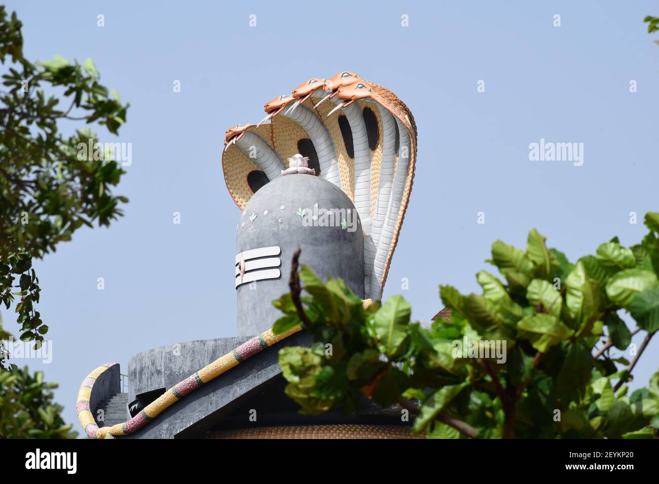 A closeup shot of a building with huge snake sculptures under a clear ...