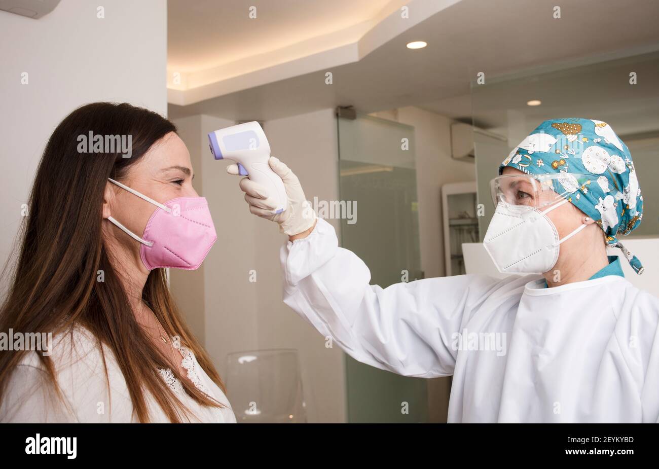 Nurse taking female patient temperature hi-res stock photography and ...