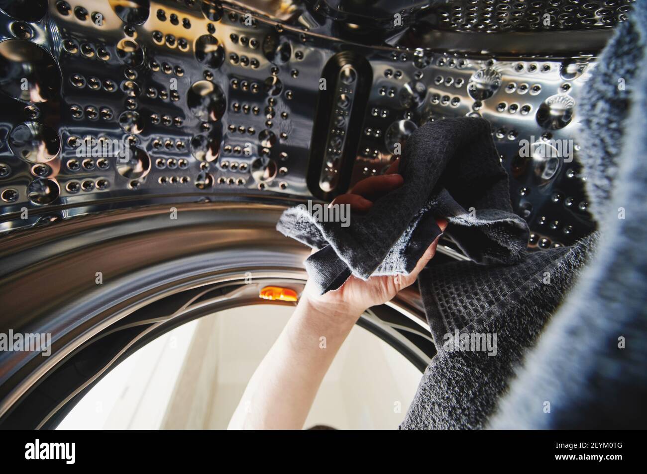 Everyday laundry theme.Hand cleaning drying washing machine Stock Photo ...