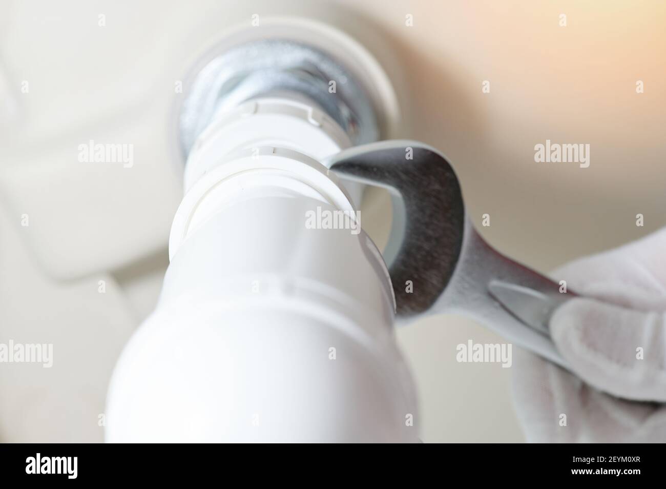 Plumber wrench fixing connection pipe close up view Stock Photo - Alamy