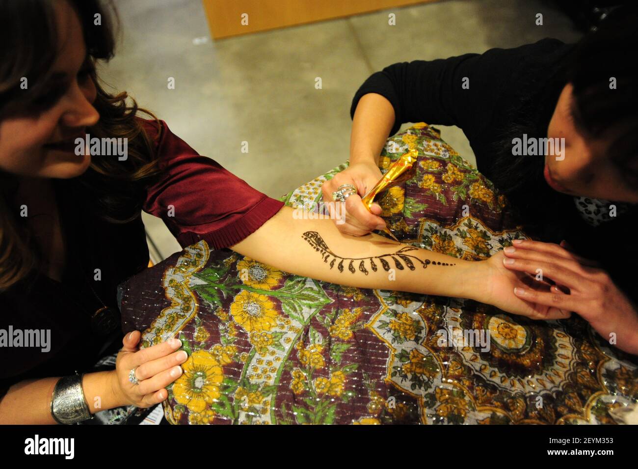 A woman gets a henna tattoo at the Carpe Mundi fundraiser. (Photo by ...