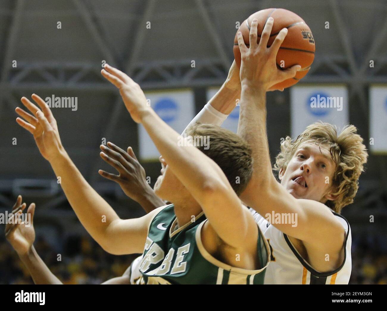 Ron Baker of Wichita State grabs a rebound against Michael Schlotman of ...