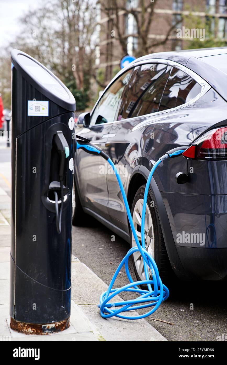 A Tesla car using a Source London EV charging point, London. Picture ...
