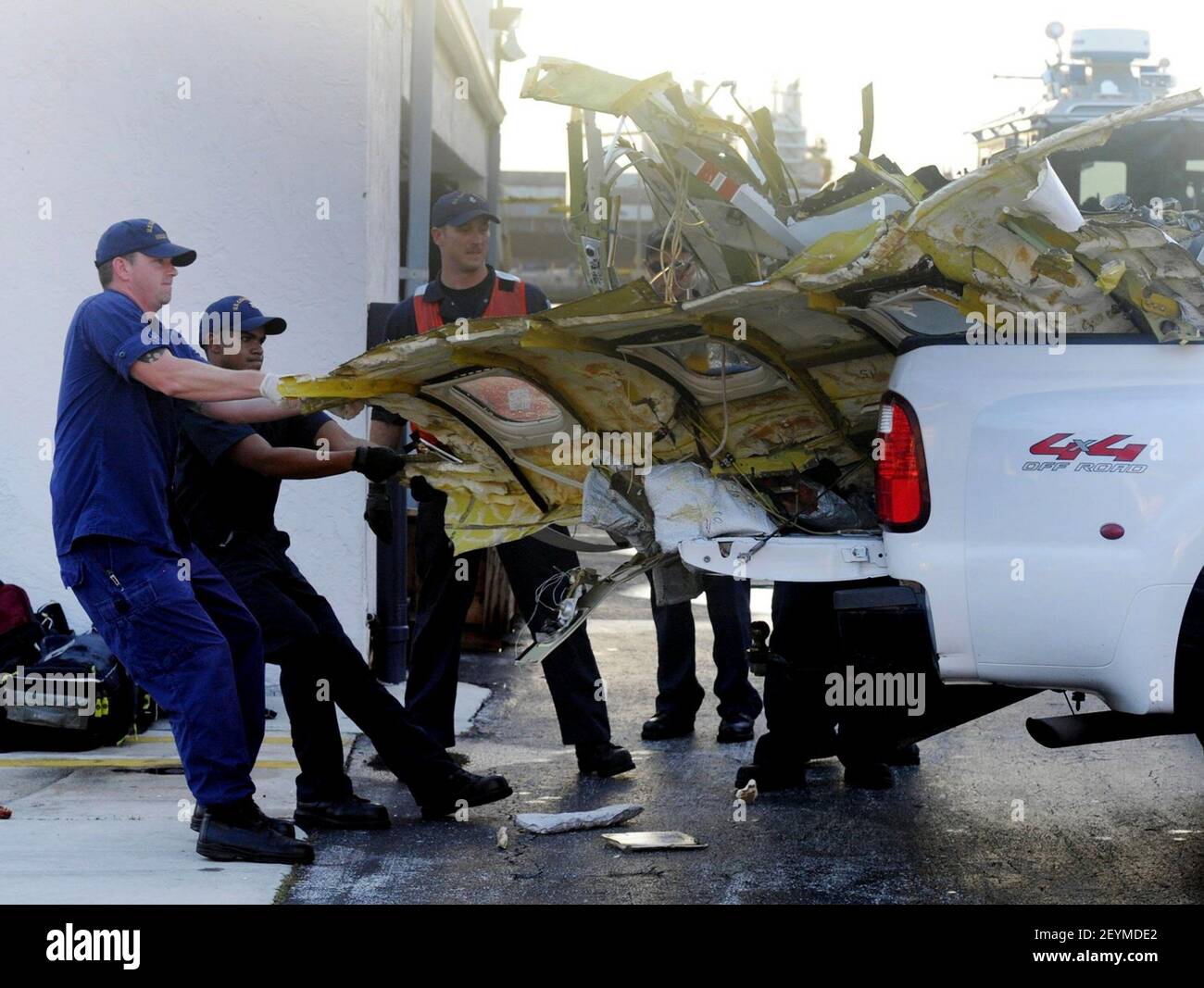 The U.S. Coast Guard unloads pieces of the Learjet 35 on Wednesday, Nov ...