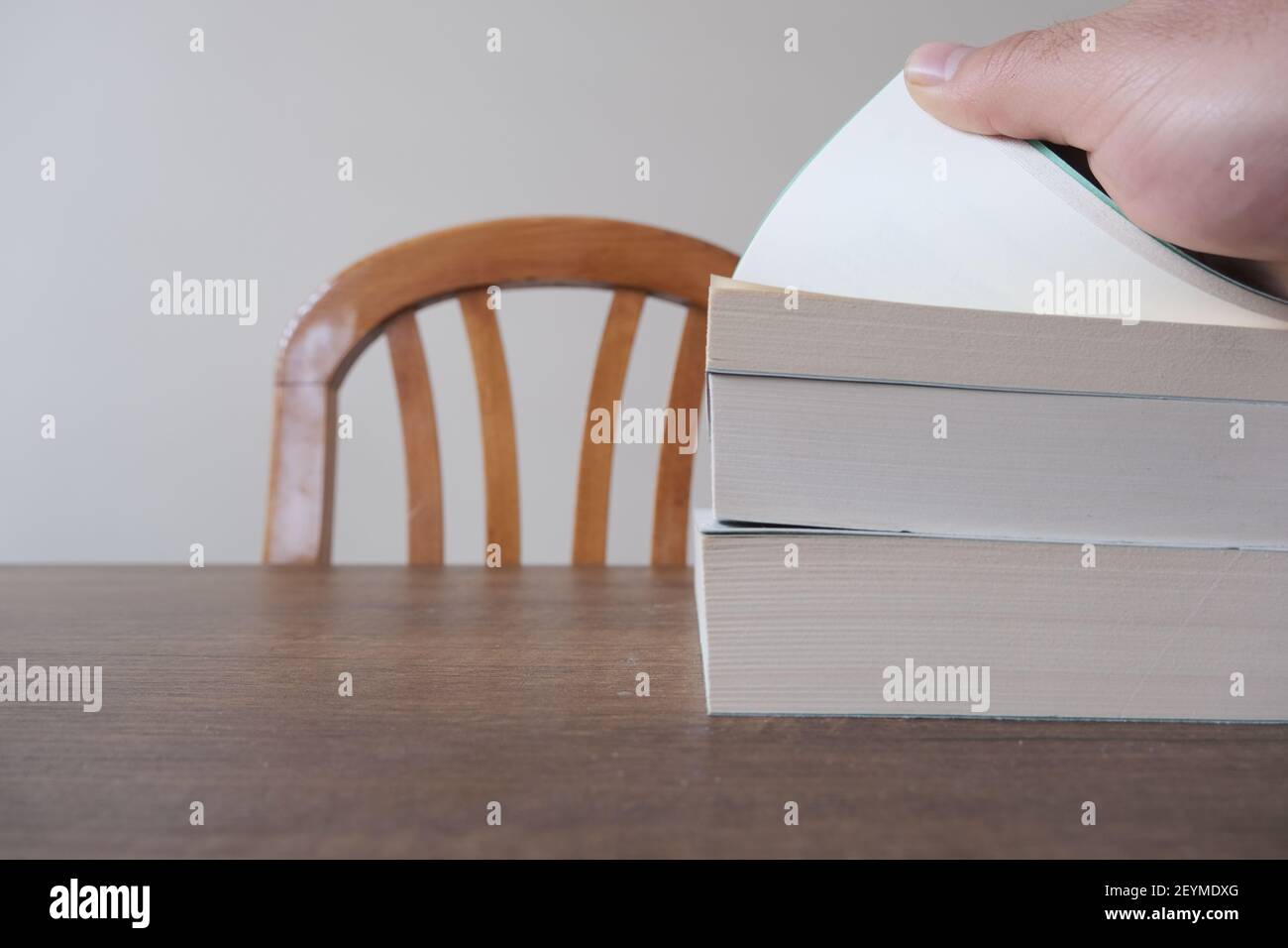 Bundle of books and leather covered note book and hand standing on ...