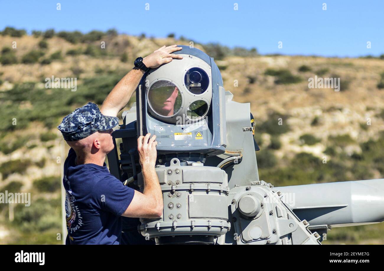 U.S. Navy Gunner's Mate 2nd Class William Tedder performs maintenance ...