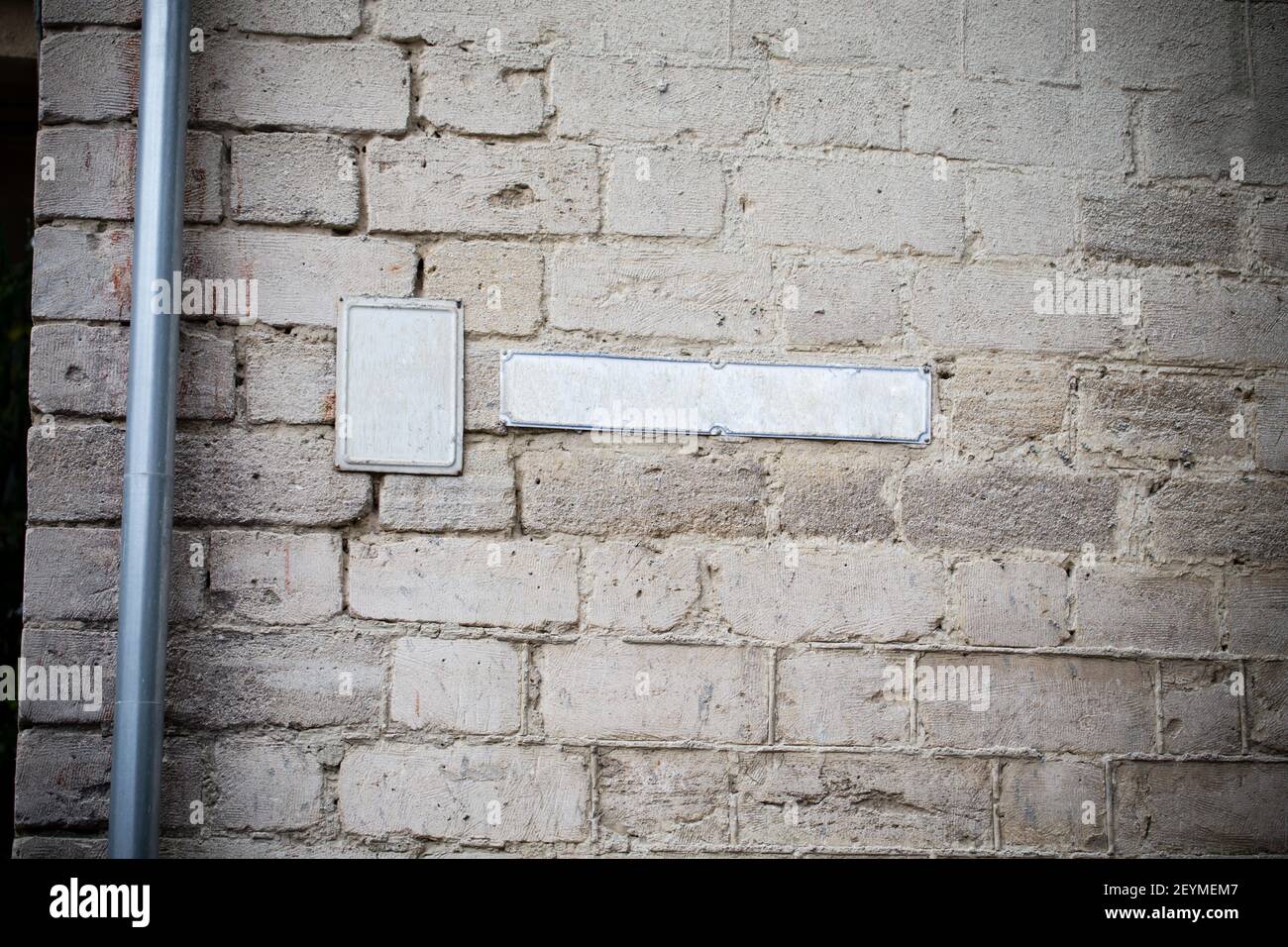 Empty house number plate on a brick wall. Photo can be used as a whole ...