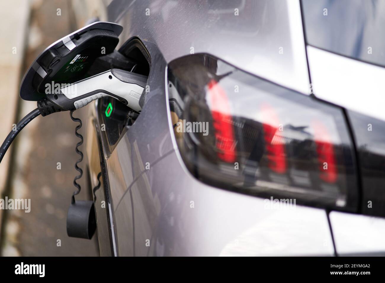 A Peugeot being charged using a Source London EV charging point, London ...