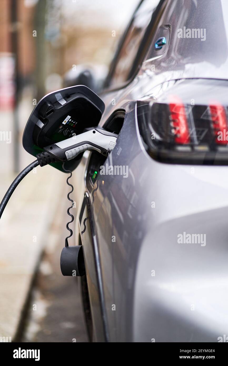 A Peugeot being charged using a Source London EV charging point, London ...