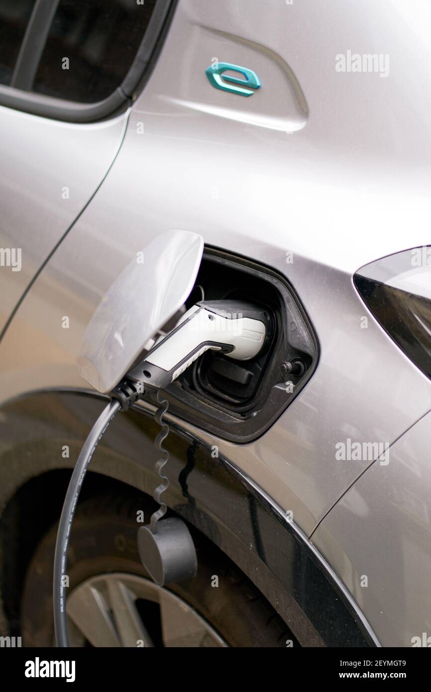 A Peugeot being charged using a Source London EV charging point, London ...