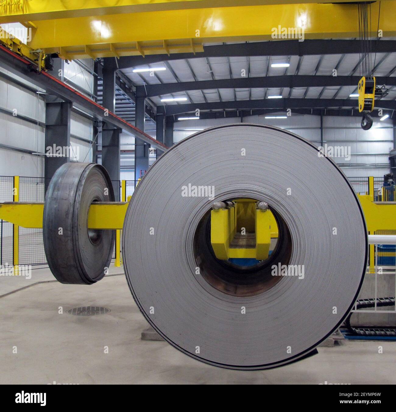 Hot-rolled coiled steel hangs at a Welded Tube of Canada factory in Lackawanna, N.Y., marking ...