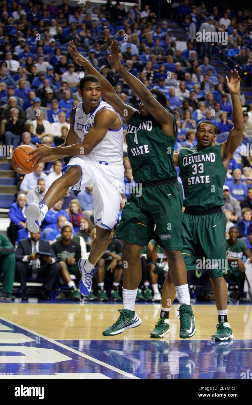 Kentucky Wildcats guard Aaron Harrison, left, passes around Cleveland ...