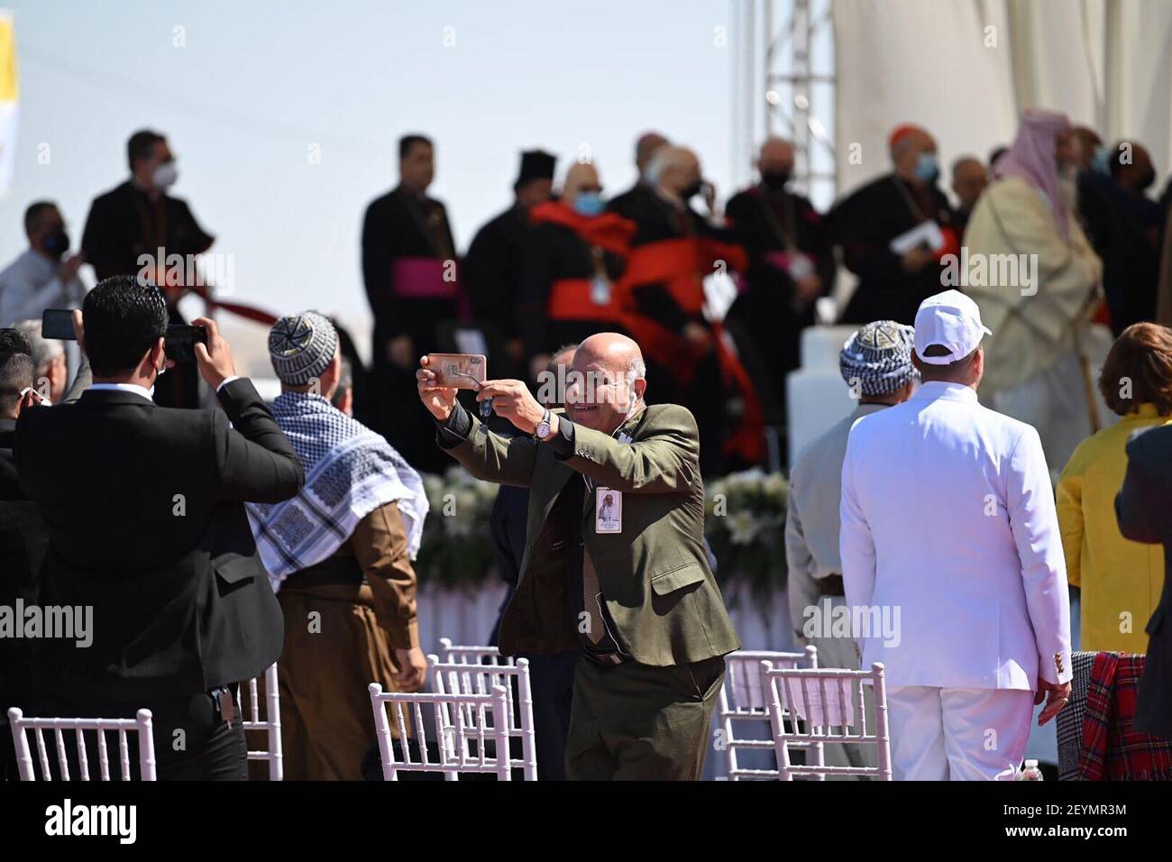 Nasiriyah, Iraq. 06th Mar, 2021. A spectator at the papal visit takes a ...